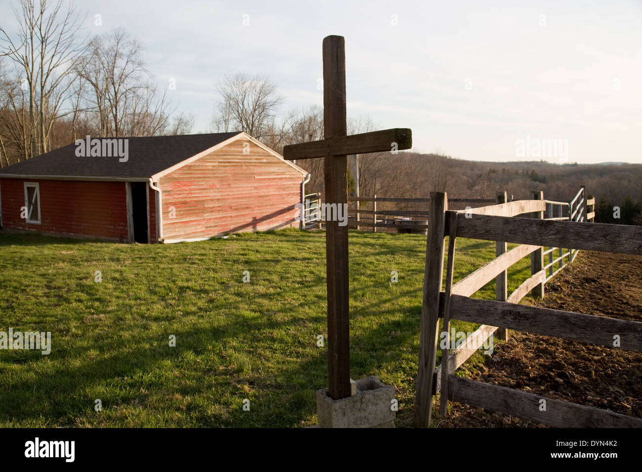 outdoor wooden cross with grass, wooden fence and red barn Stock Photo ...