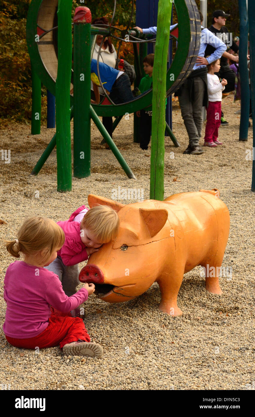 Little girls playing with pig model at a playground in Budapest Hungary ...
