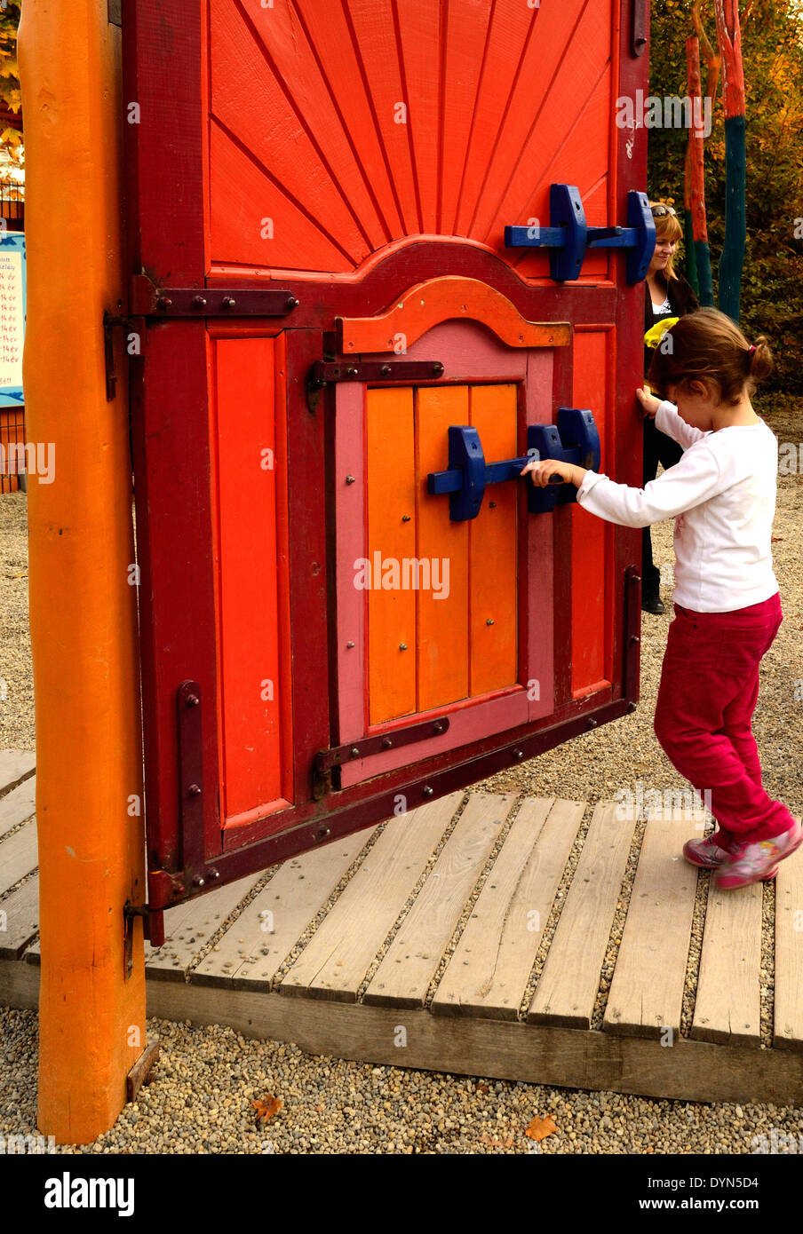 Little girl on the playground to play with door toy, Budapest Hungary ...