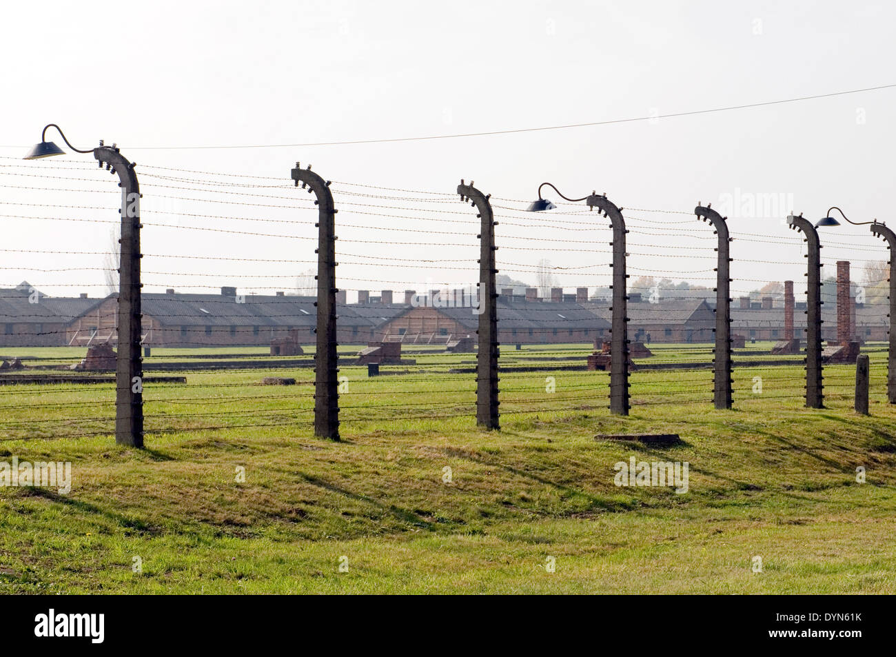 poles and barbed wire fence surrounding Auschwitz concentration camp ...