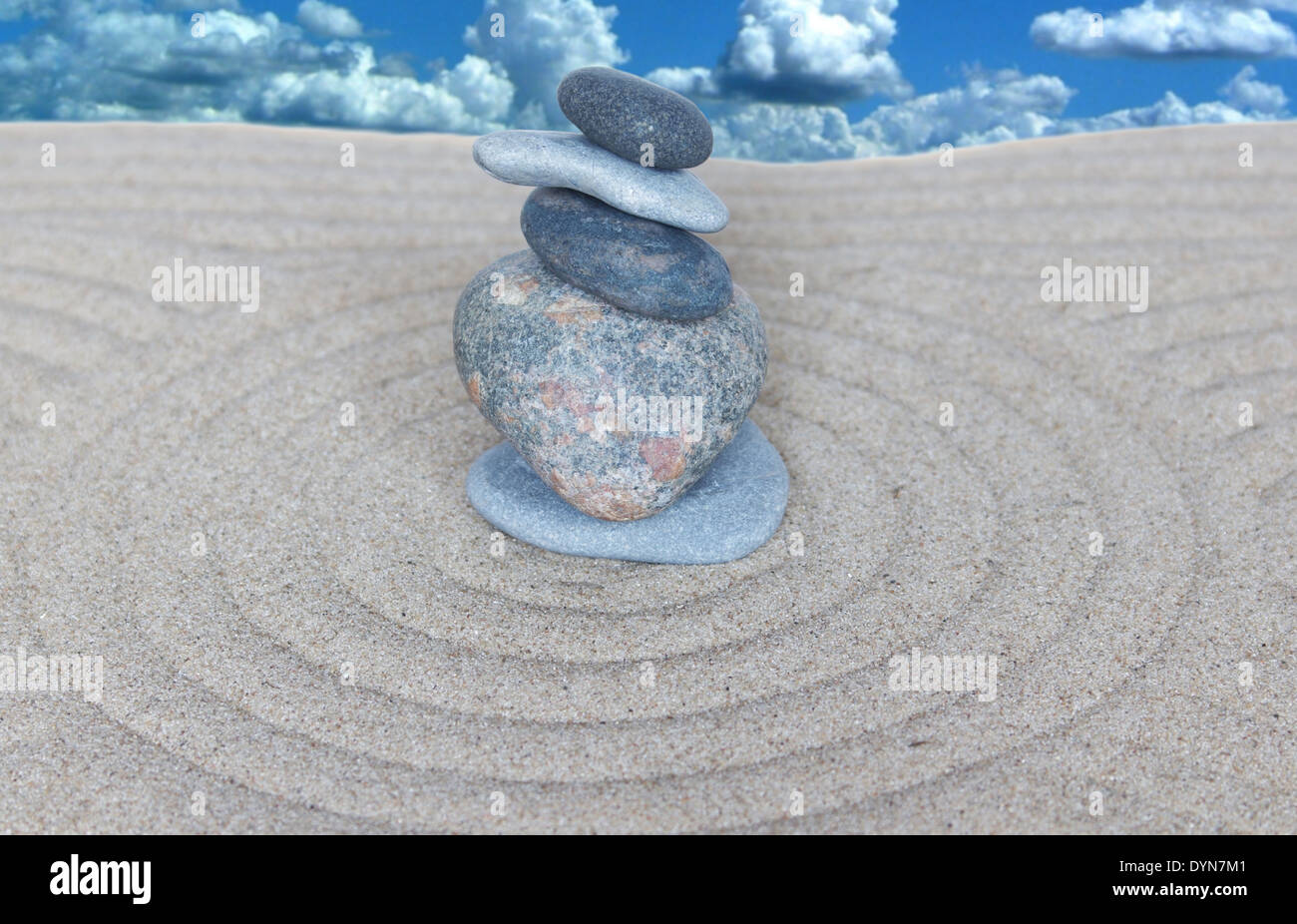 pyramid with five stones on sand and sky background Stock Photo - Alamy