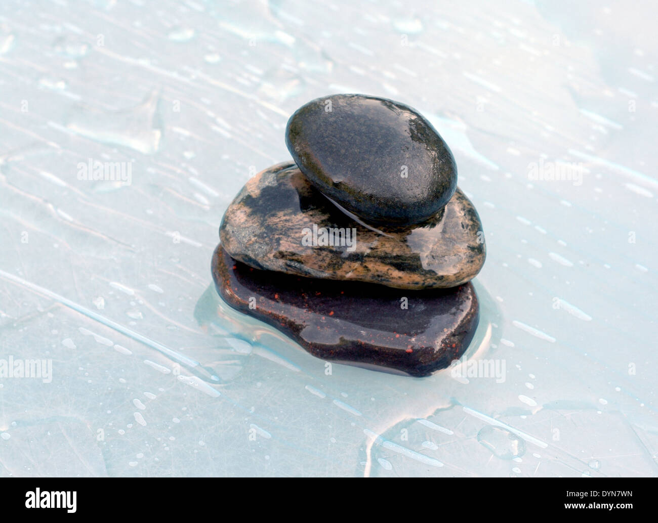 pyramid from three stones in water Stock Photo - Alamy