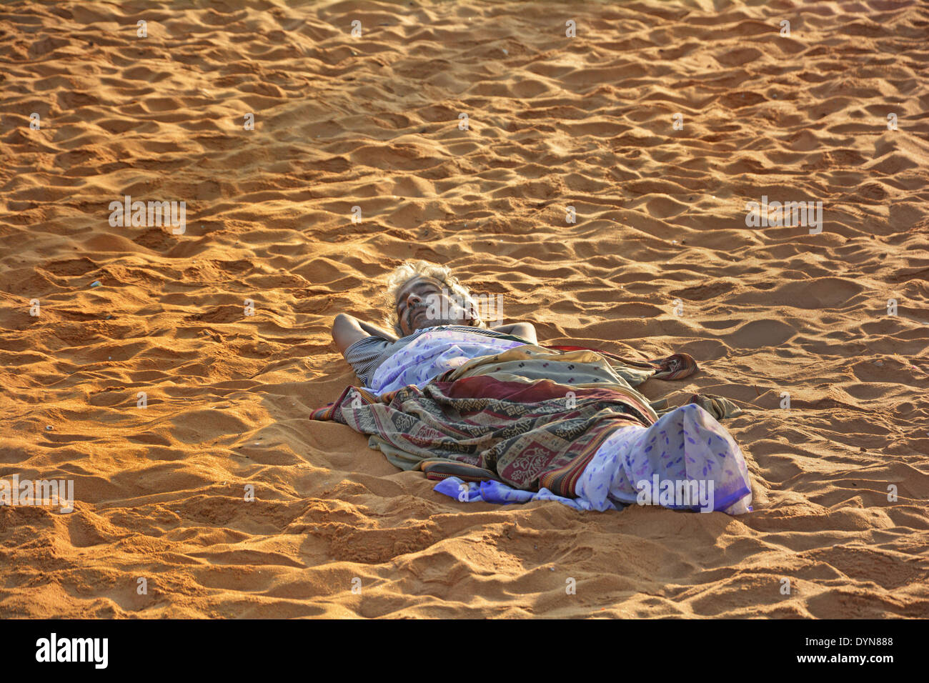 man sleeping on sand Stock Photo - Alamy