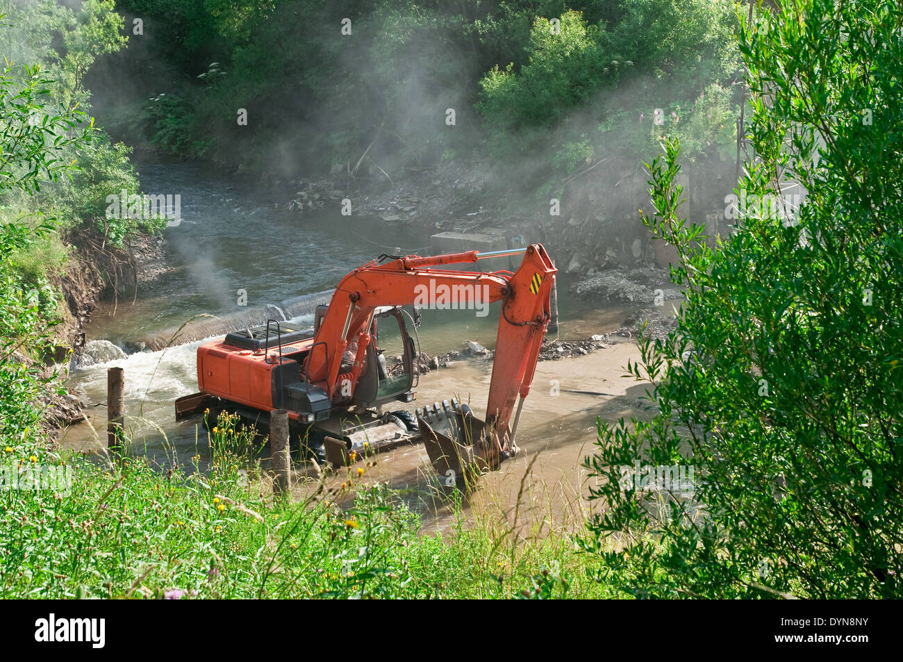 Excavator loader loader working in the river Stock Photo - Alamy