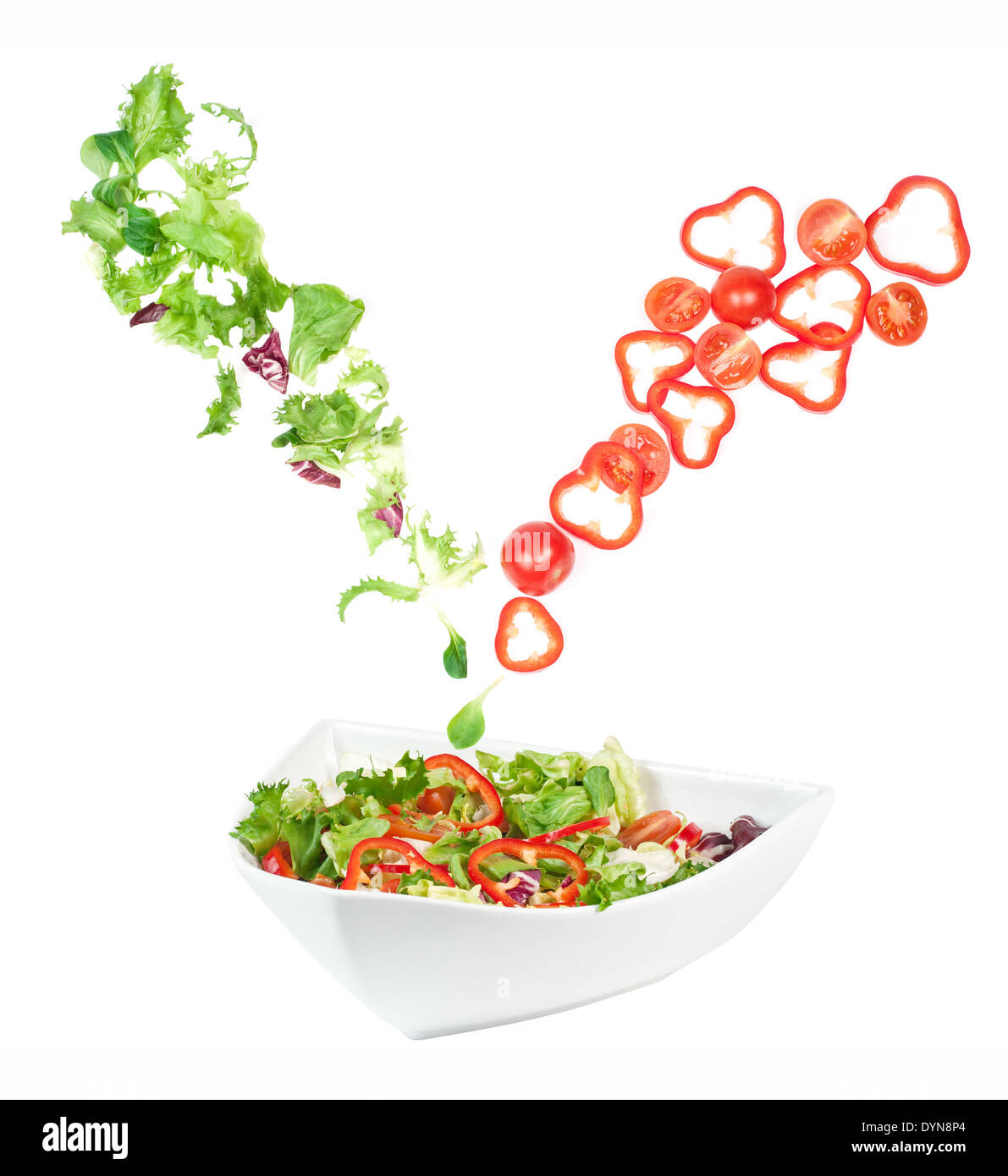 Fresh mixed vegetables falling into a bowl of salad Stock Photo - Alamy