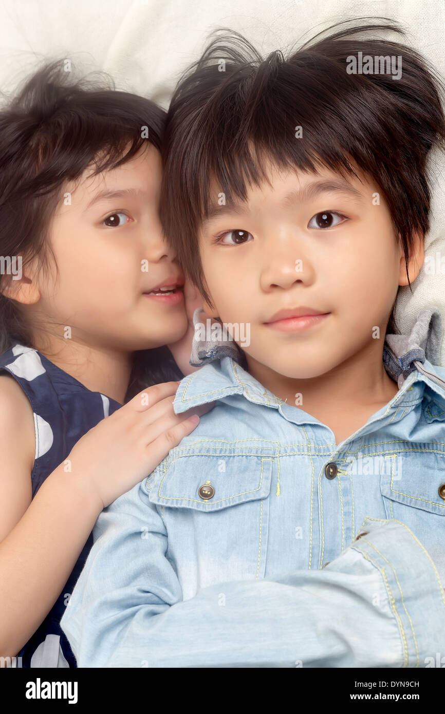 Kids talking while lying on bed Stock Photo - Alamy