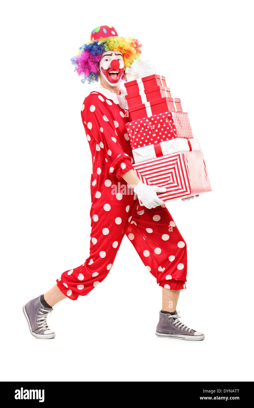 Male clown carrying a pile of presents Stock Photo - Alamy