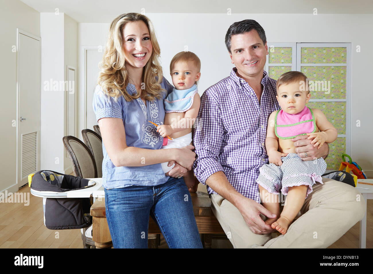 Caucasian family smiling in dining room Stock Photo - Alamy