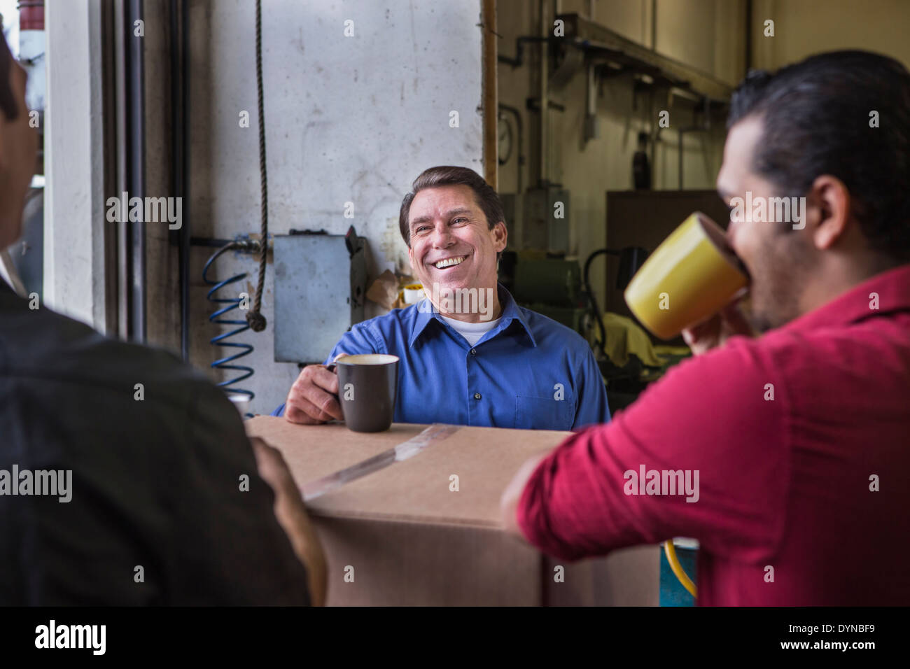 Workers enjoying coffee break in warehouse Stock Photo - Alamy