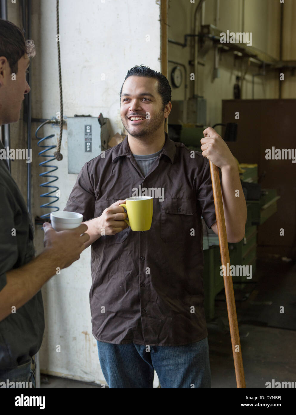Workers having coffee together in warehouse Stock Photo - Alamy