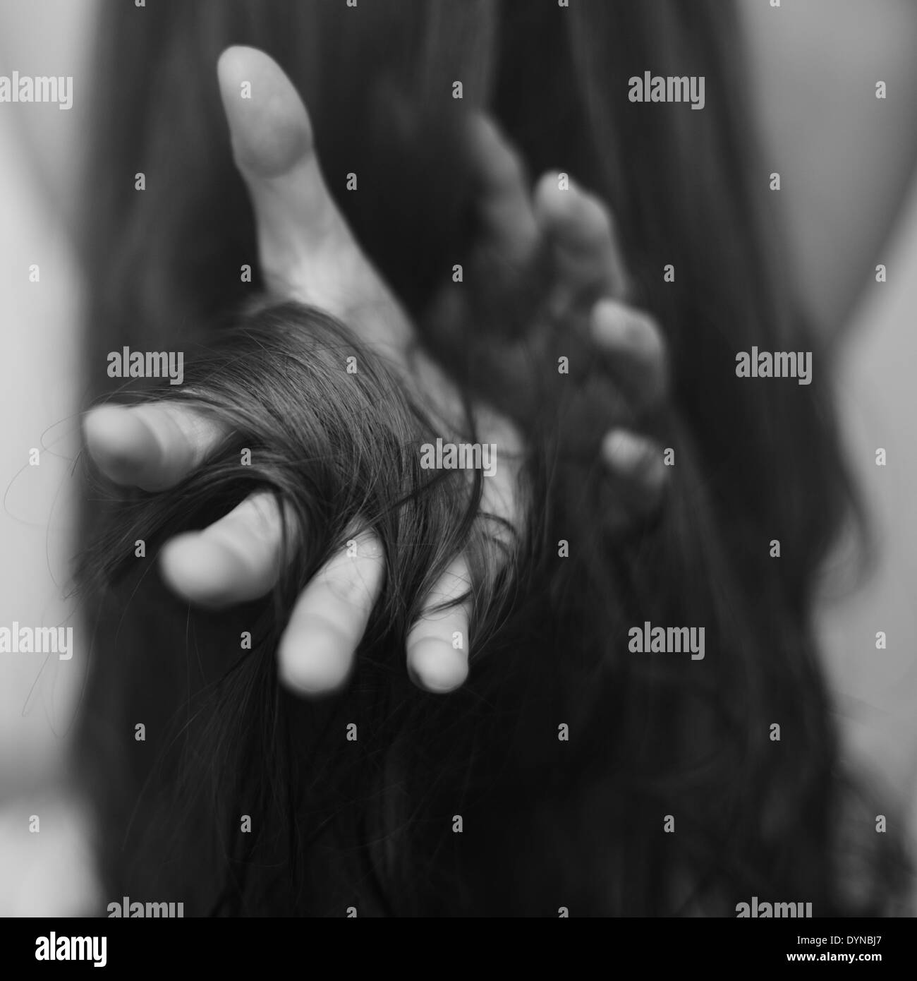 Hair wrapped around Caucasian woman's hand Stock Photo - Alamy