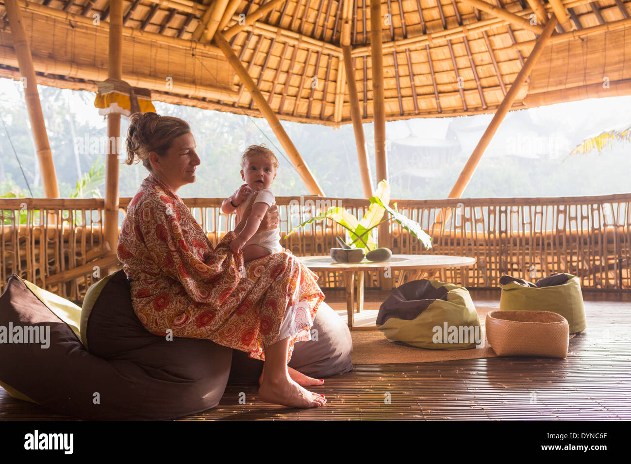 Caucasian mother bouncing baby on knee Stock Photo - Alamy