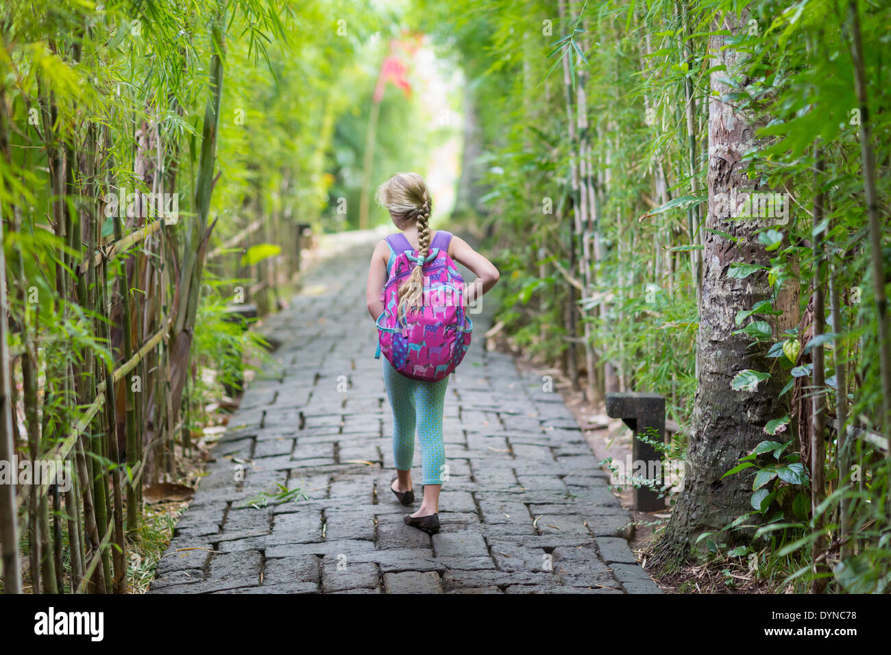 Caucasian girl walking on stone path among bamboo trees Stock Photo - Alamy