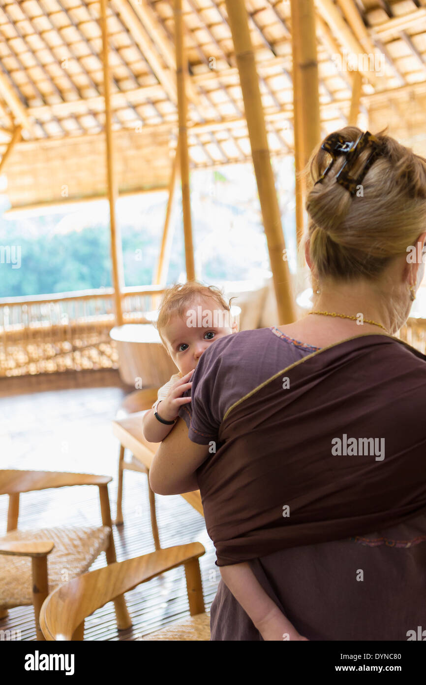 Caucasian mother carrying baby boy on patio Stock Photo - Alamy