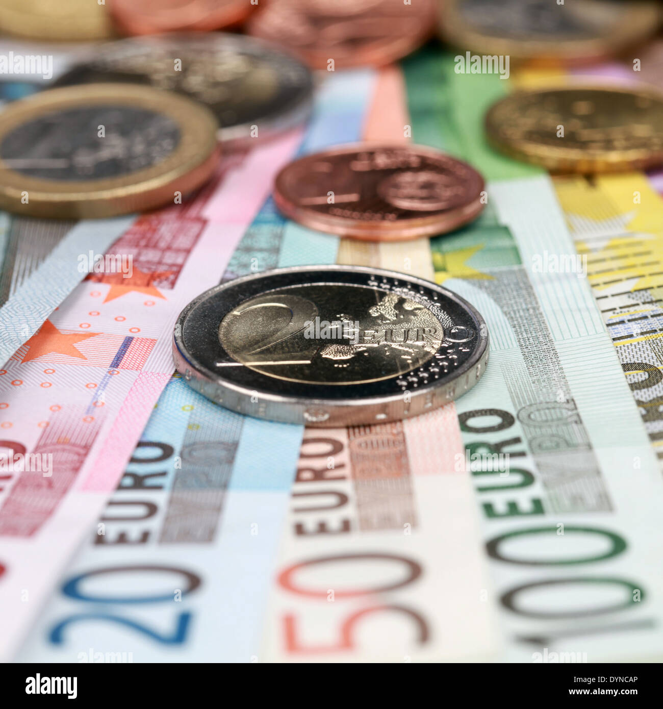 Two Euro coin on different Euro banknotes, shallow depth of field Stock ...