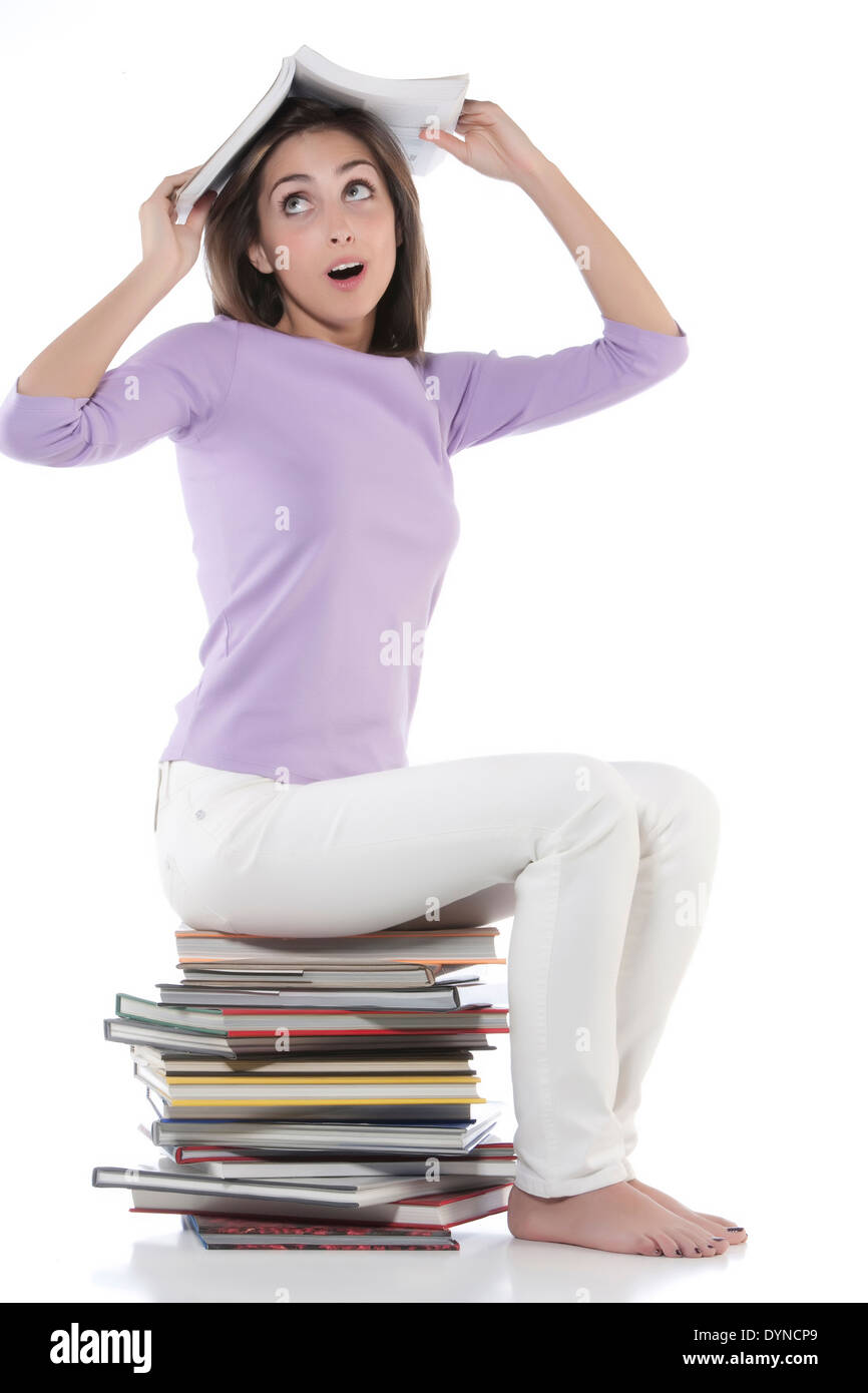 Woman sitting on stack of books Stock Photo - Alamy