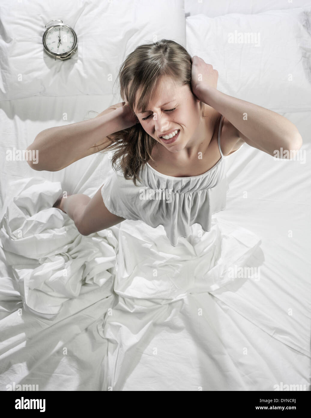Woman covering ears alarm clock hi-res stock photography and images - Alamy