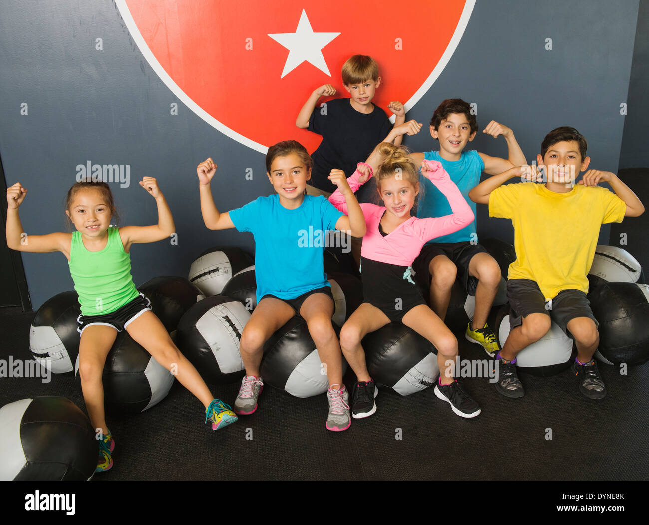 Children flexing their muscles in gym Stock Photo - Alamy