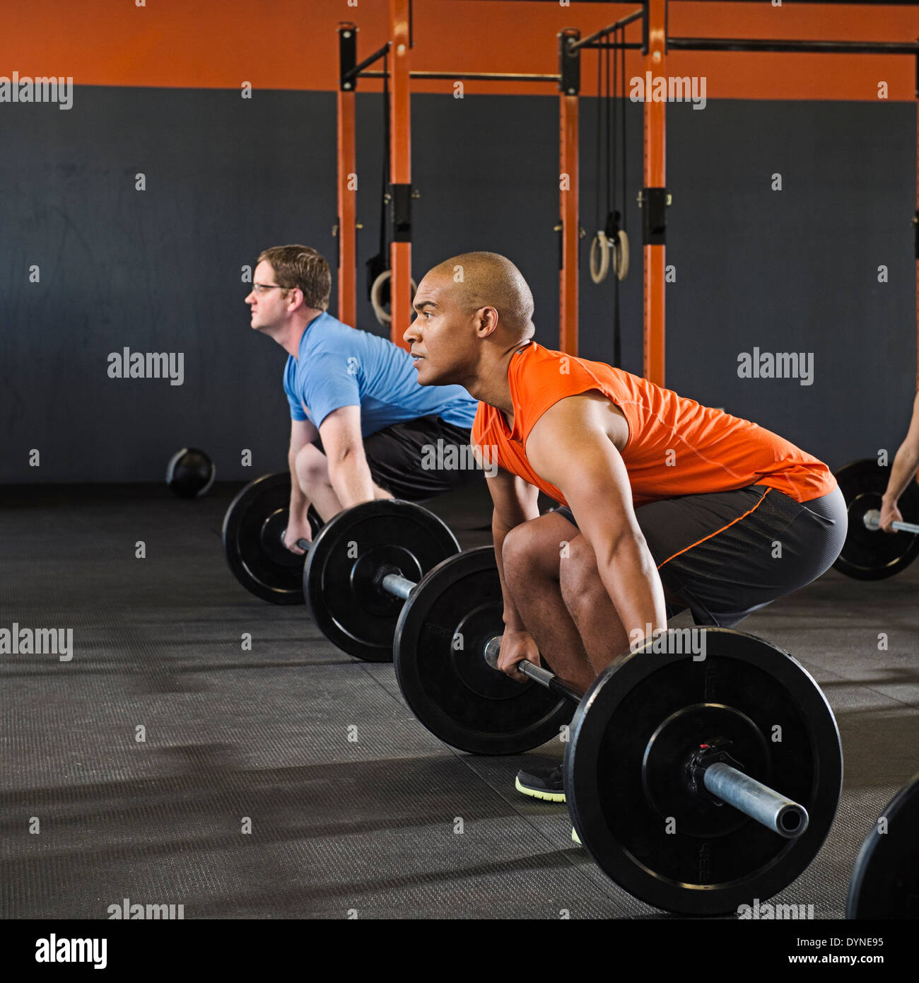 Men lifting weights in gym Stock Photo - Alamy