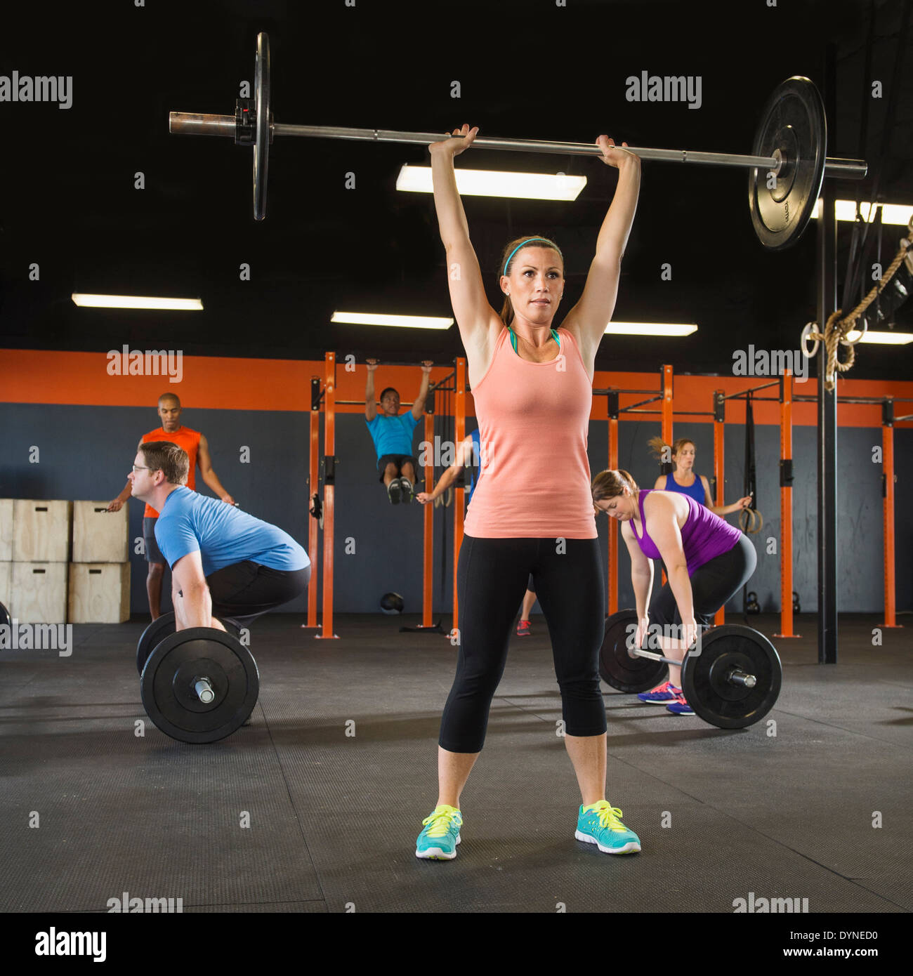 People lifting weights in gym Stock Photo - Alamy