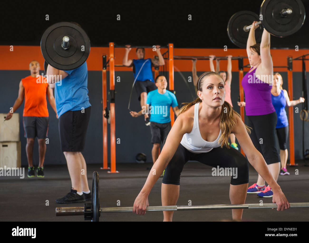 People lifting weights in gym Stock Photo - Alamy