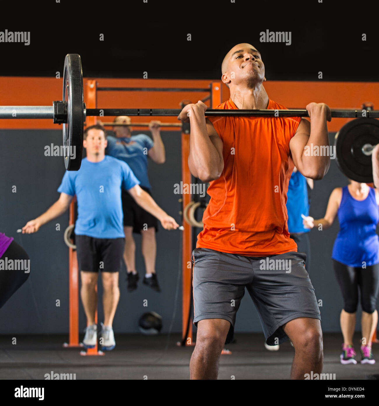 Man lifting weights in gym Stock Photo - Alamy