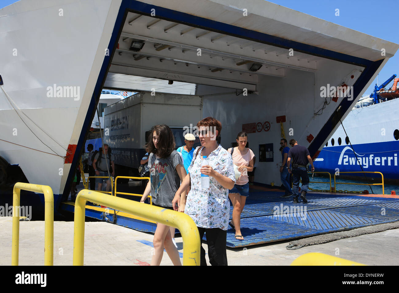 Vehicles and people going on and off ferries at Igoumenitsa a busy ...