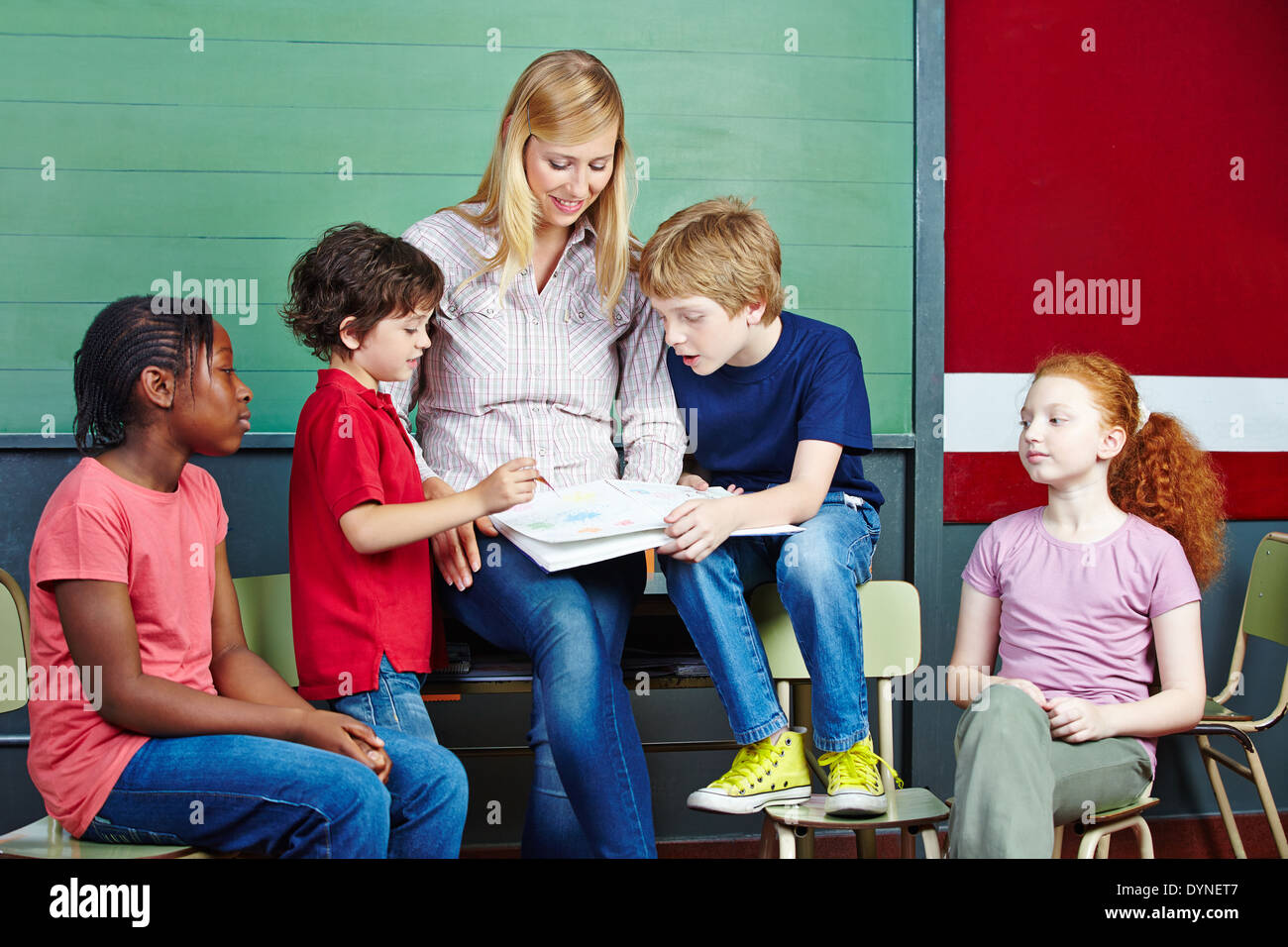 Students and teacher learning together in elementary school class Stock ...