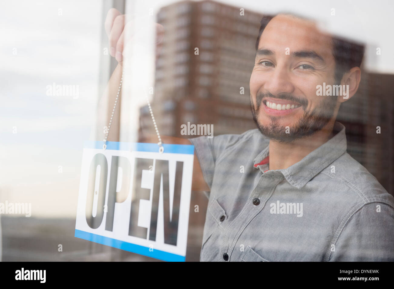 Man turning close sign to open sign hi-res stock photography and images ...