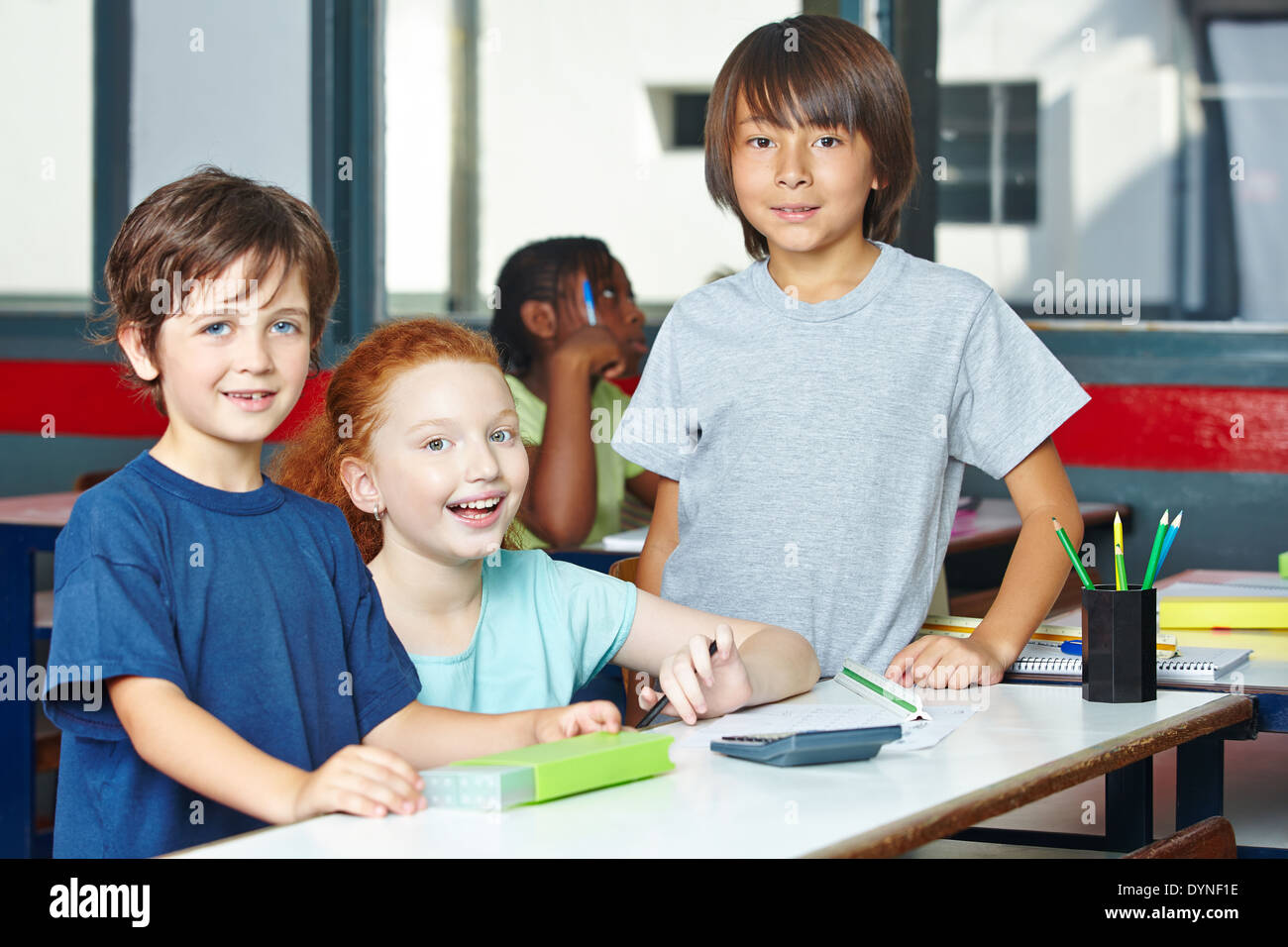 Students learning together in a group in elementary school class Stock ...