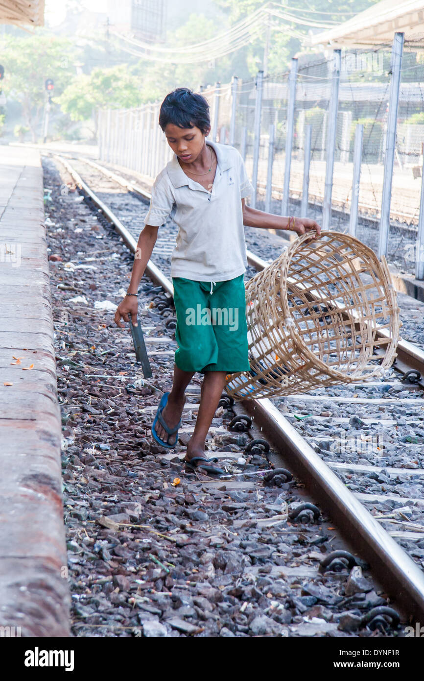 boy collecting rubbish off the track at the station Stock Photo - Alamy