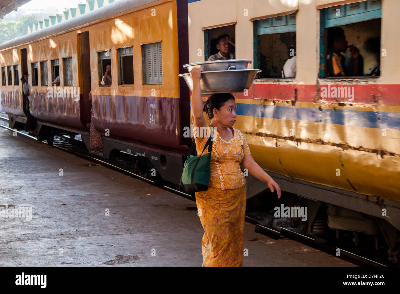 Women carrying food on her head in the station Yangon Myanmar Burma ...