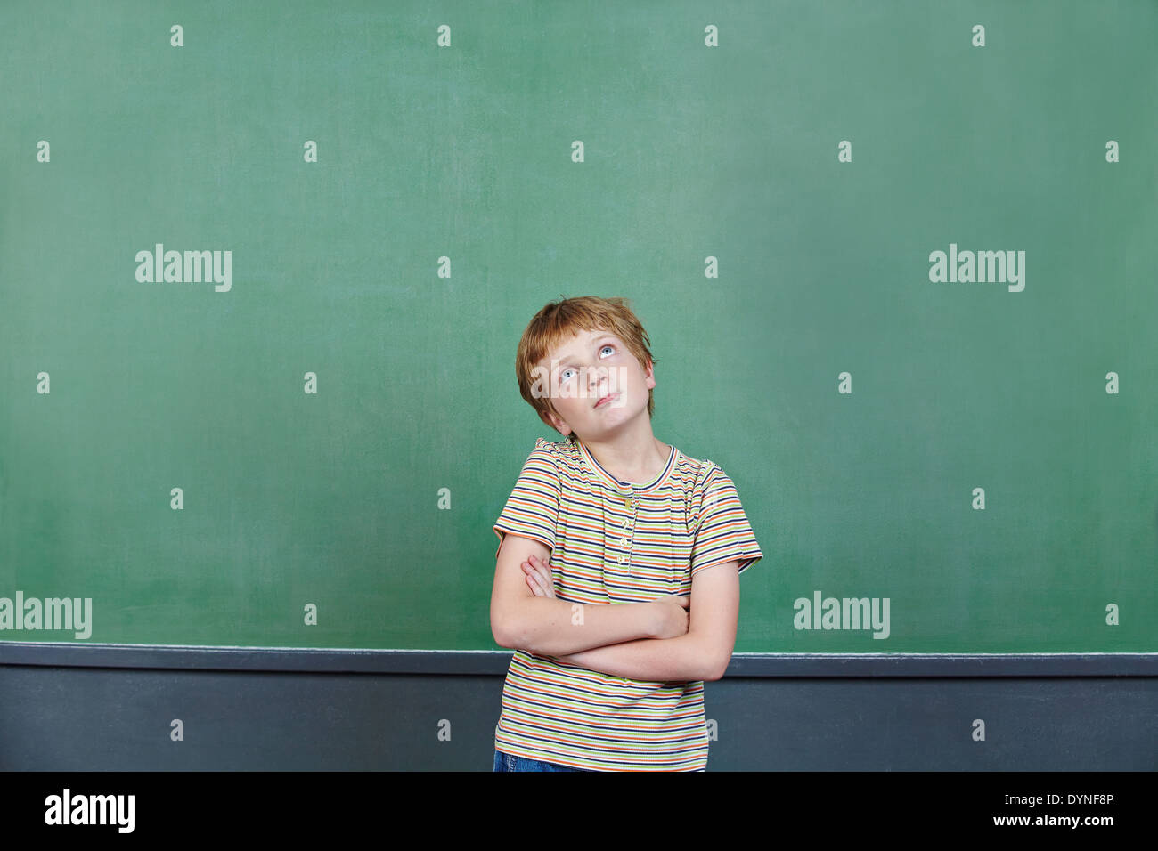 Child thinking in front of empty chalkboard in elementary school Stock ...