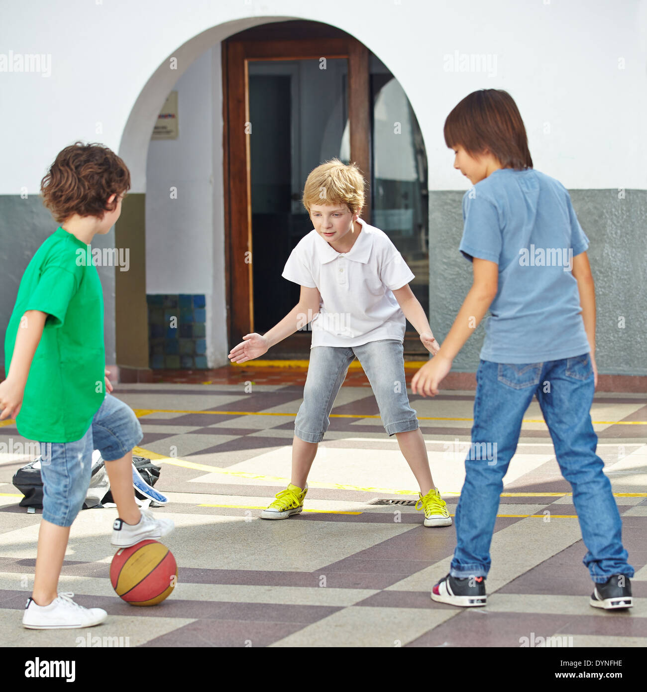 Boys playing with ball on schoolyard in an elementary school Stock ...