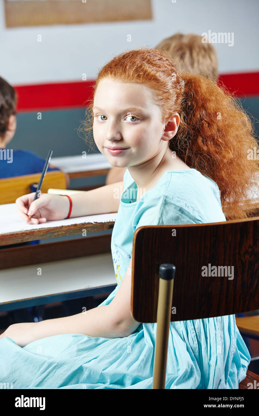 Female student sitting in elementary school class at a table Stock ...