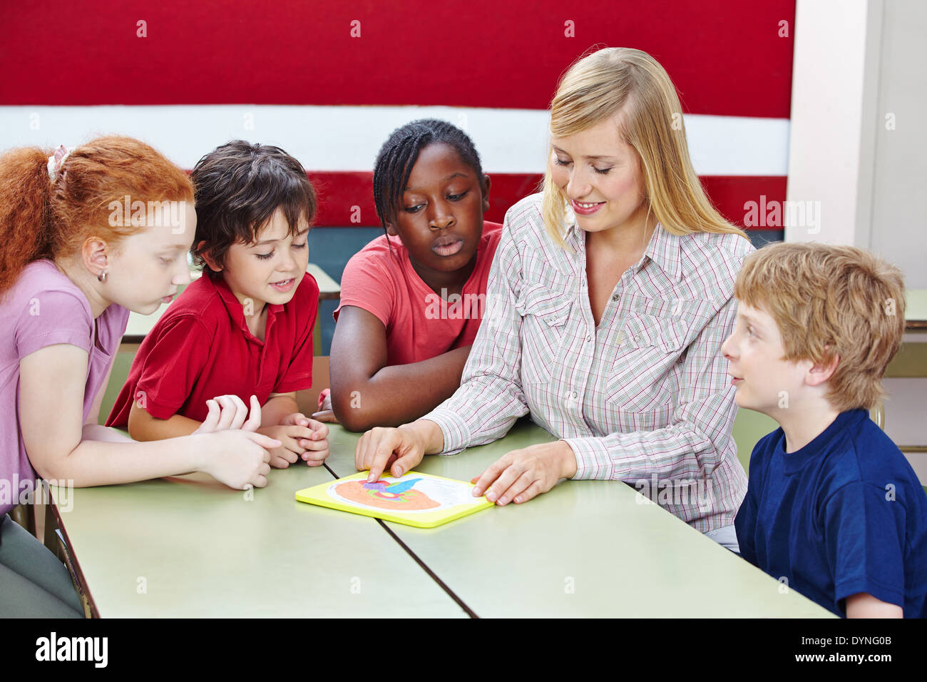 Students and teacher in biology class talking about the human brain ...