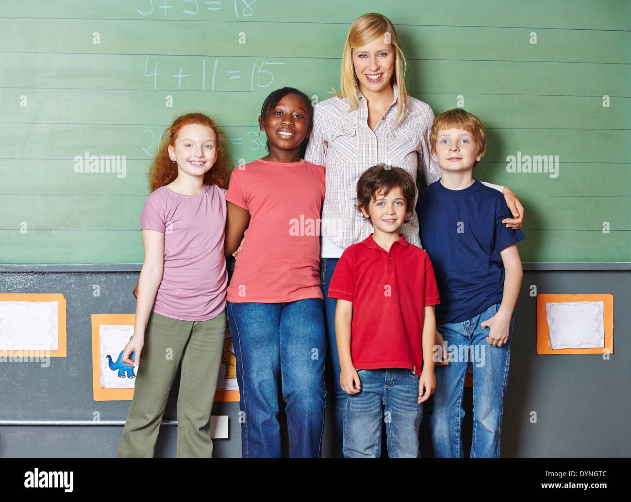 Teacher with her class of students in elementary school in front of a ...