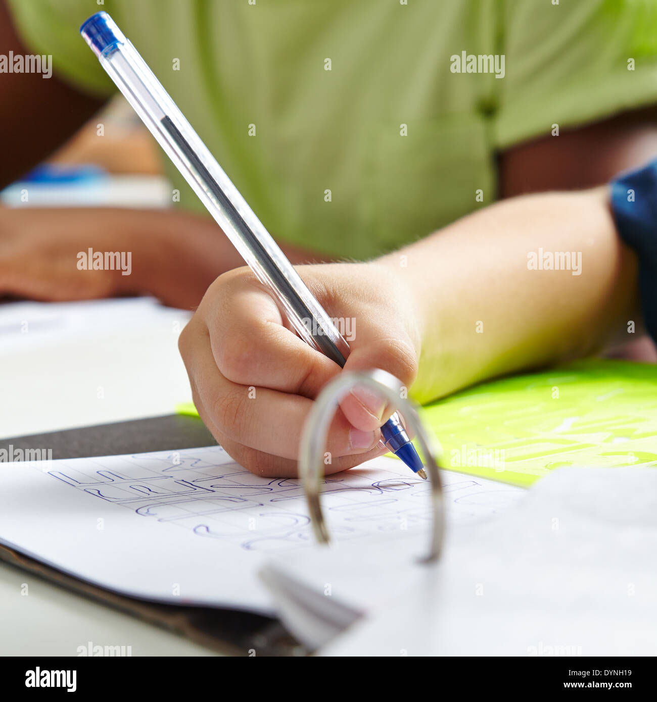Hand of child writing with pen in elementary school class Stock Photo ...