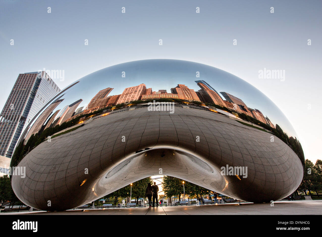 Cloud Gate Sculpture or The Bean with downtown skyline reflected in ...