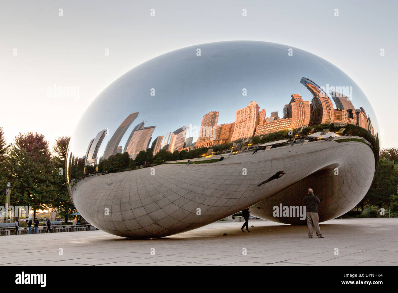 Cloud Gate Sculpture or The Bean with downtown skyline reflected in ...