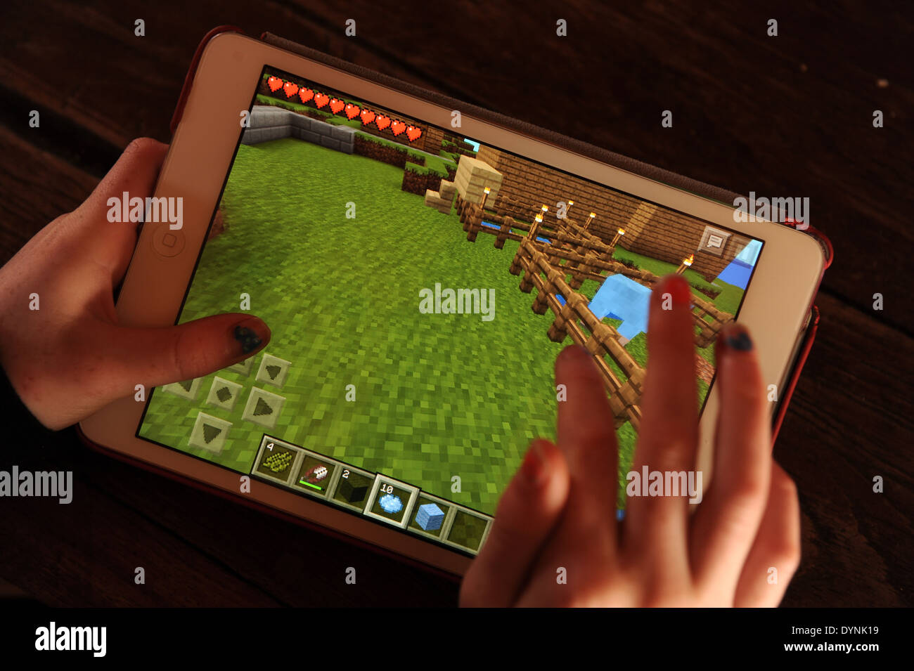 Young girl playing Minecraft on an apple ipad Stock Photo - Alamy