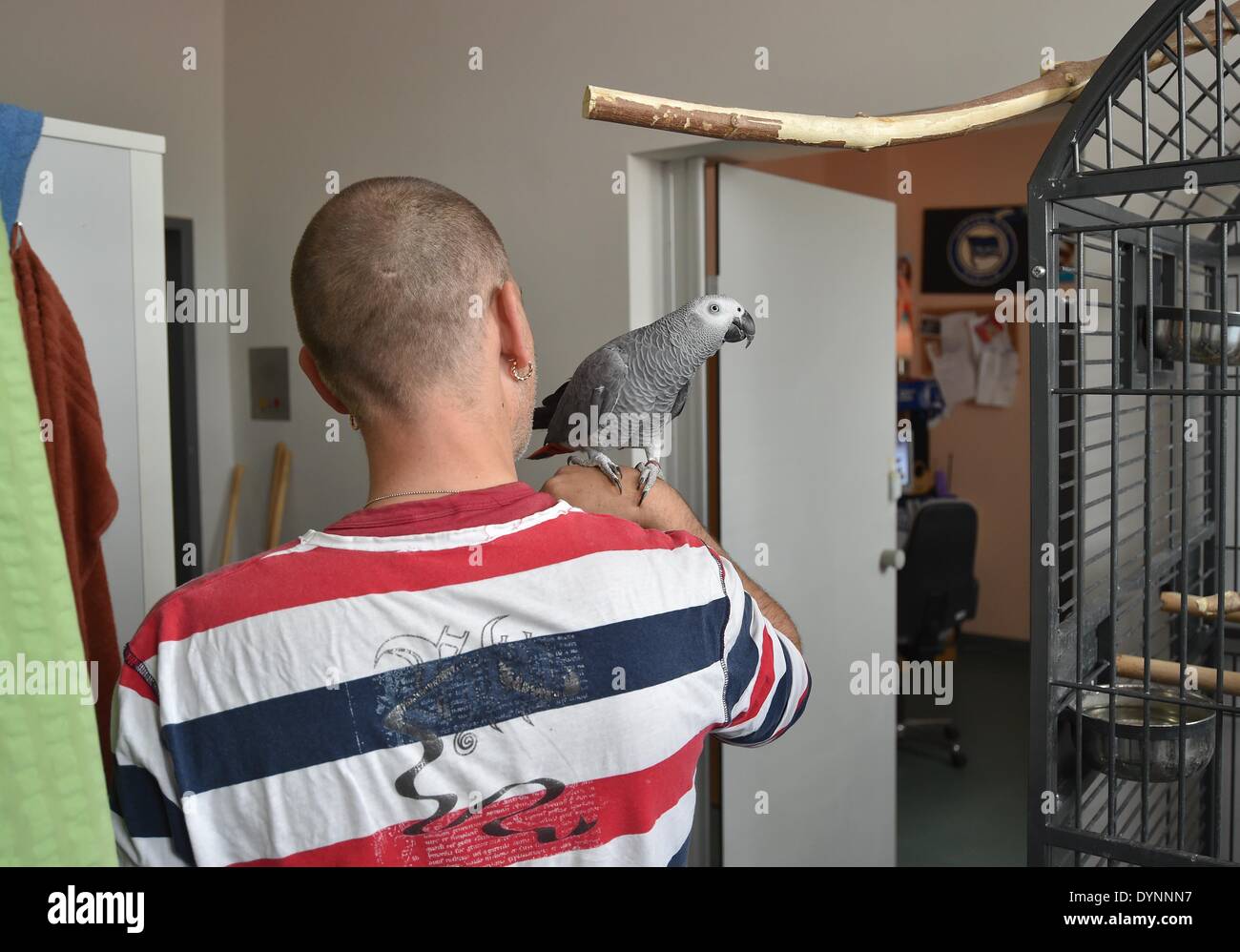 An inmate with his parrot is pictured in his living area of the ...