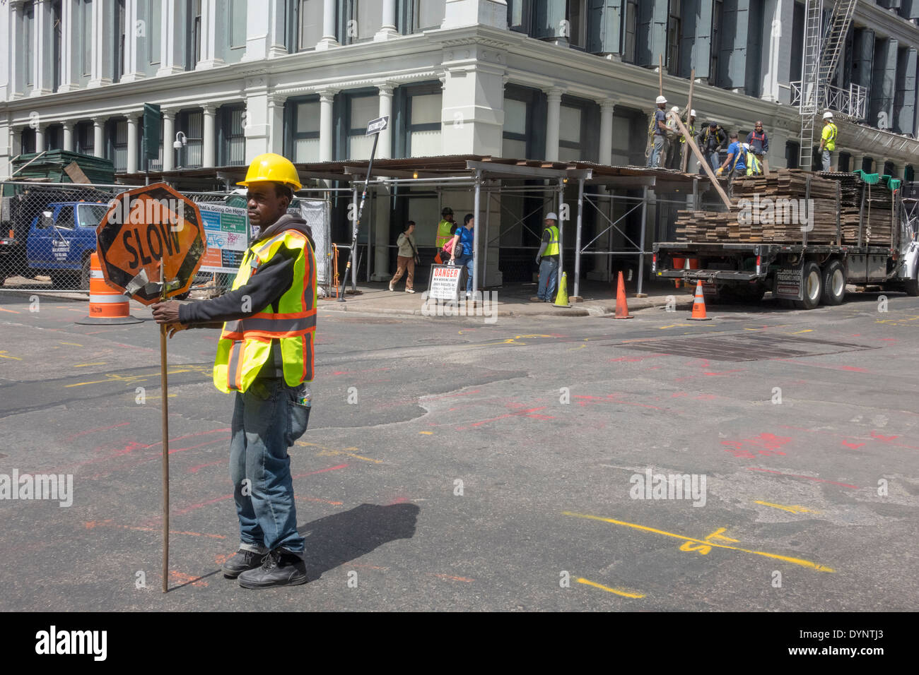 Construction worker controlling street traffic on building site in New ...