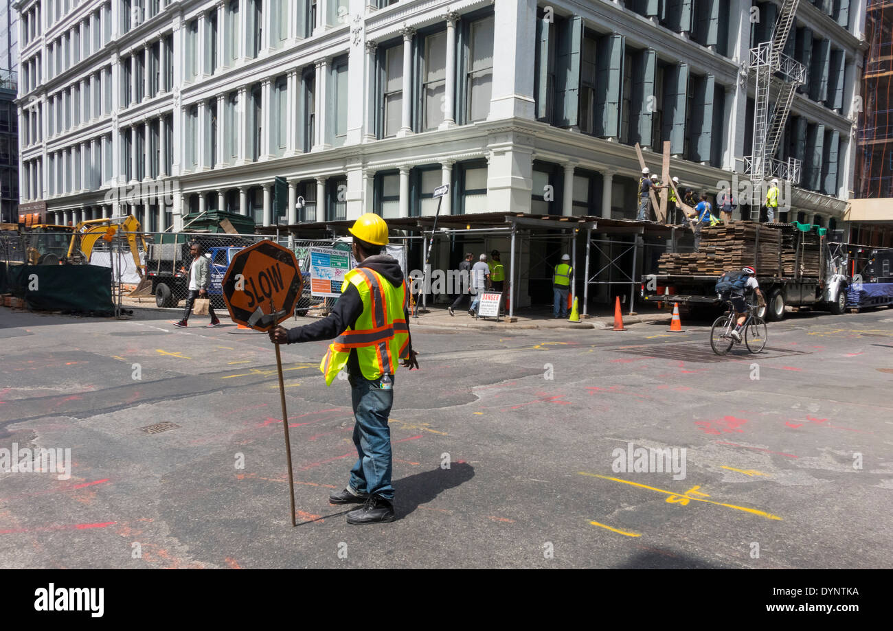 A construction worker controlling the traffic flow on a work site Stock ...