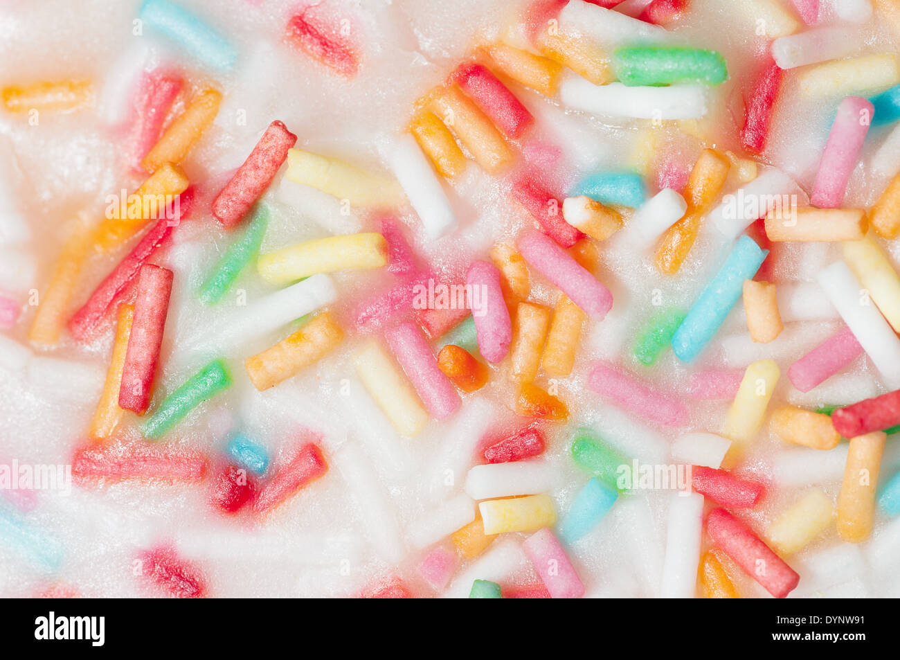 Sprinkle colored sugar on the frosting Stock Photo - Alamy