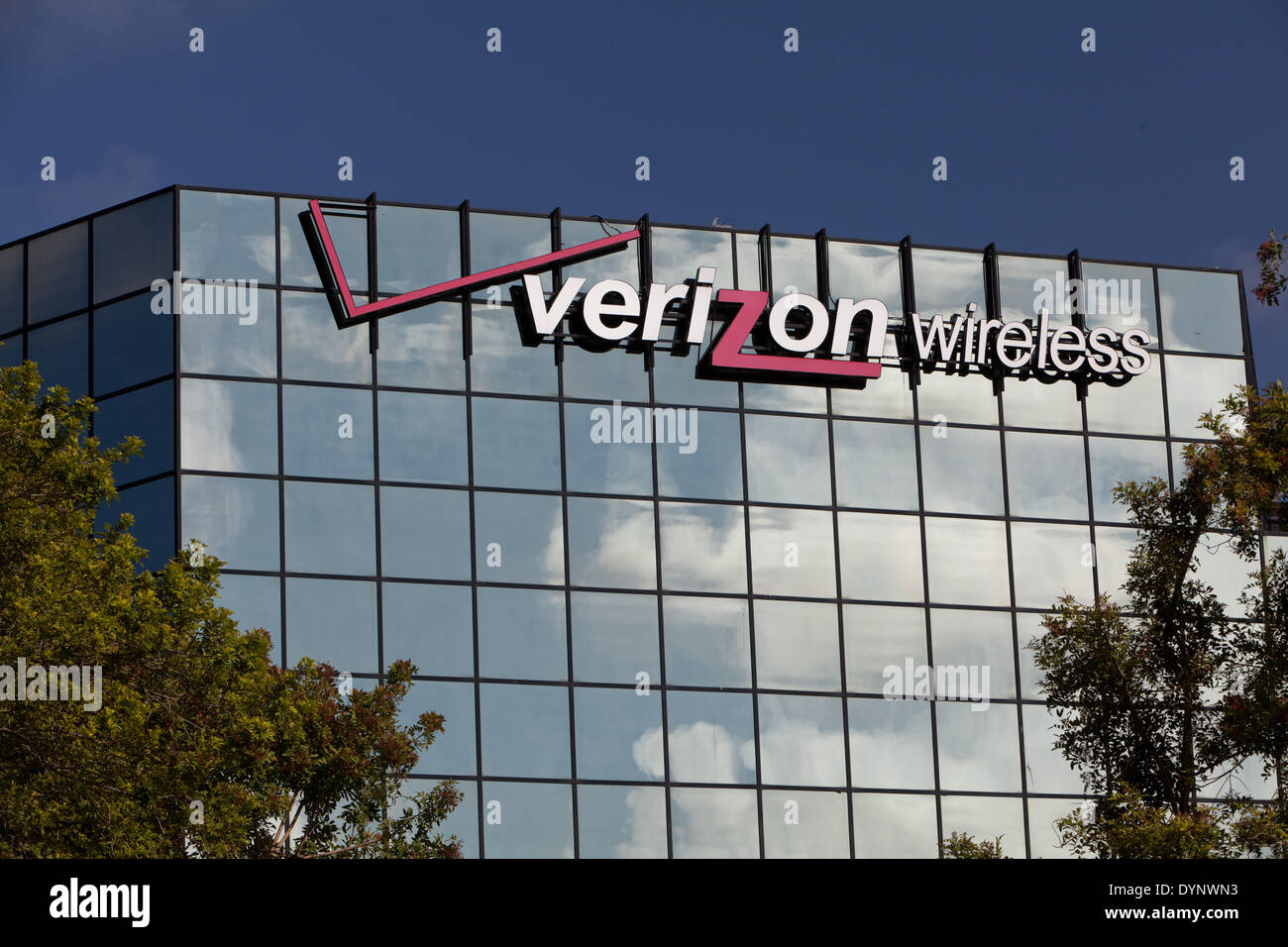 Corporate logo of Verizon wireless on the mirrored-glass of an office ...