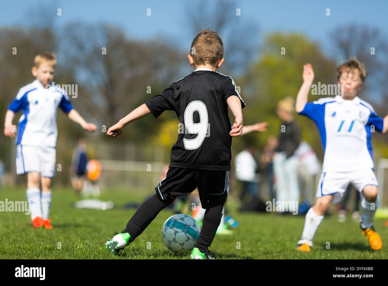Children playing football hi-res stock photography and images - Alamy