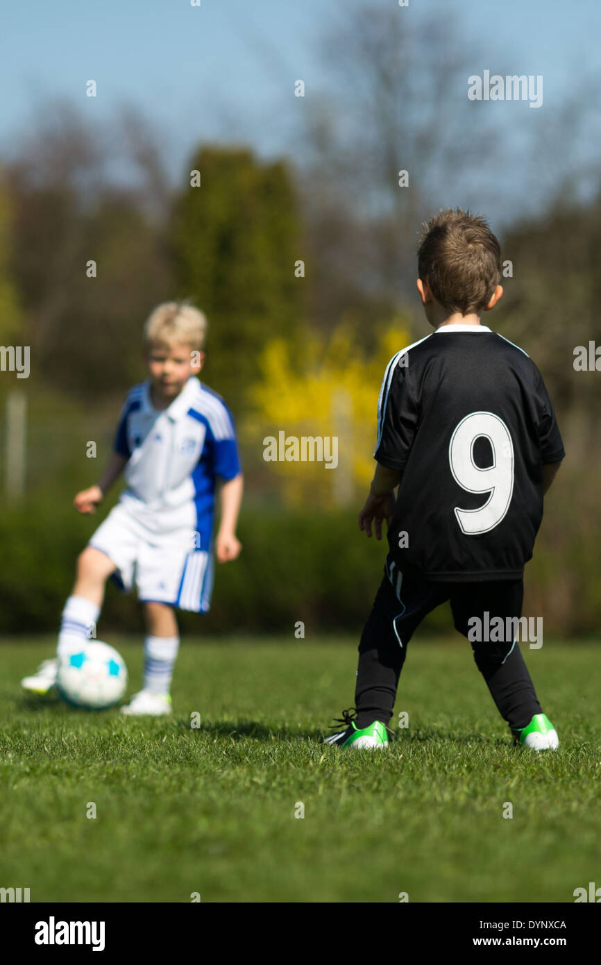 Two kids playing football hi-res stock photography and images - Alamy