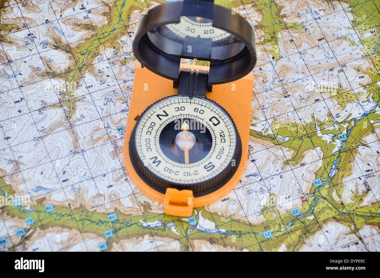 Compass in the black case on an orange ground open the mirror cover is ...