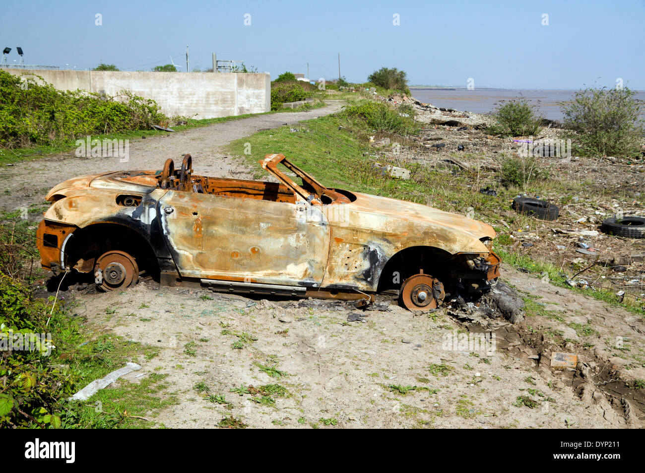 Burnt out car blocking Wales Coast Path, Rover Way, Cardiff, South ...